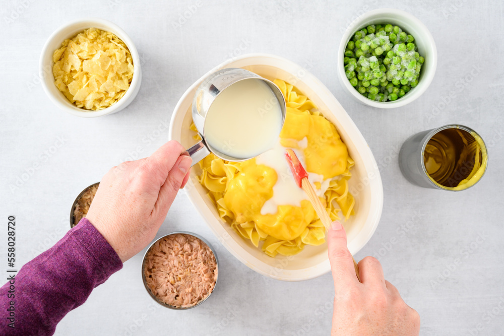 Dinner meal preparation, woman’s hand mixing together ingredients for ...