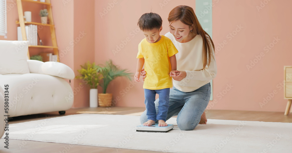 child standing on a scale Stock Photo | Adobe Stock
