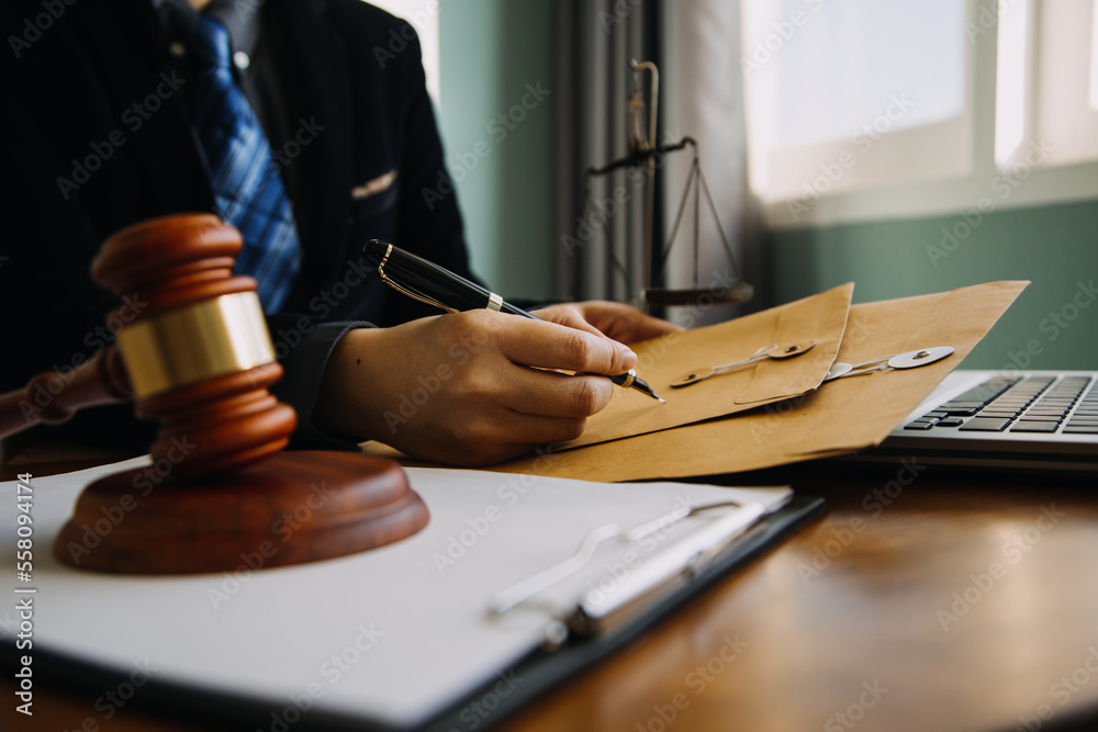 Business and lawyers discussing contract papers with brass scale on desk in office. Law, legal ...