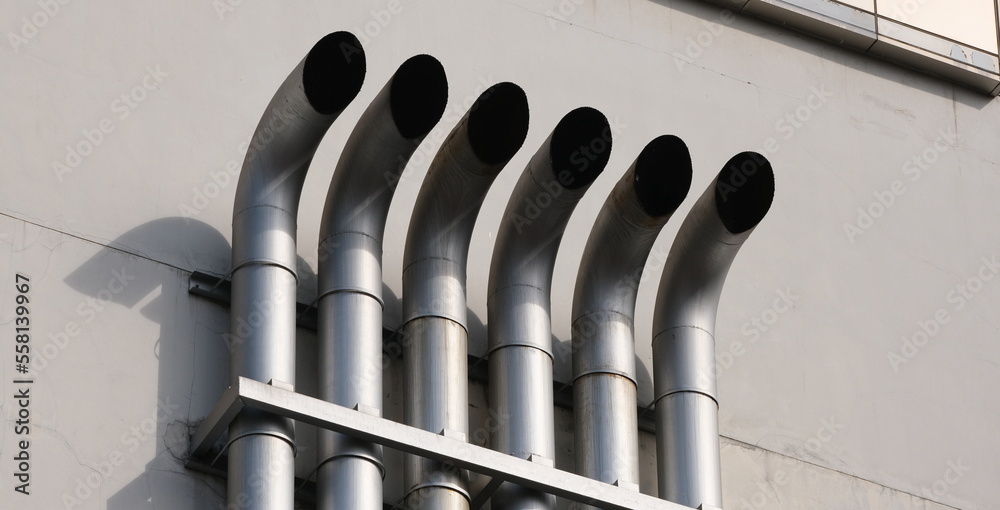 Industrial vent pipes on building facade Stock Photo | Adobe Stock