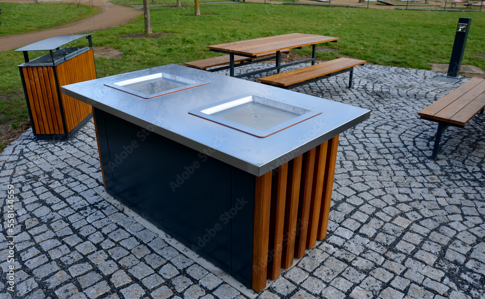 Park seating, wooden tables and benches picnic and barbecue, gas grill ...