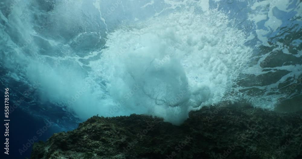 choppy water wavy sea underwater wave hit on rocks and makes foam on ...