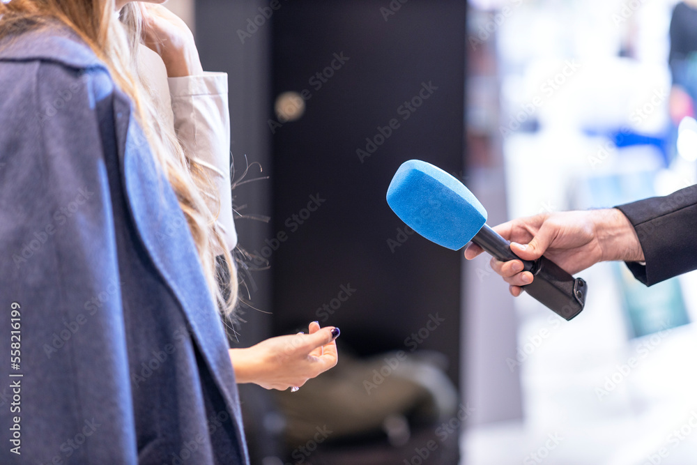 News reporter making media interview with unrecognizable female person ...