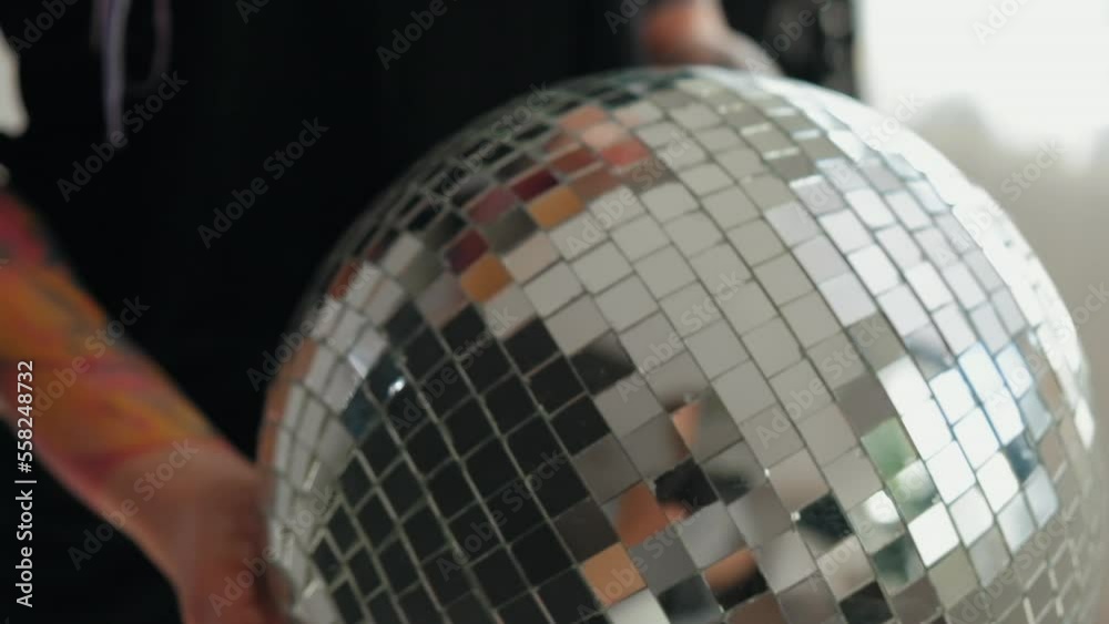 a girl with dreadlocks is standing in a white studio and twirling a ...
