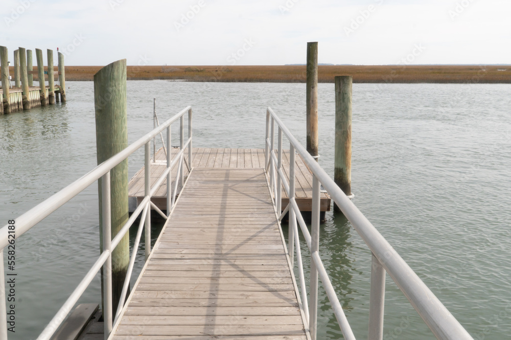 a view down a modern boarding ramp with metal hand rails on both sides ...