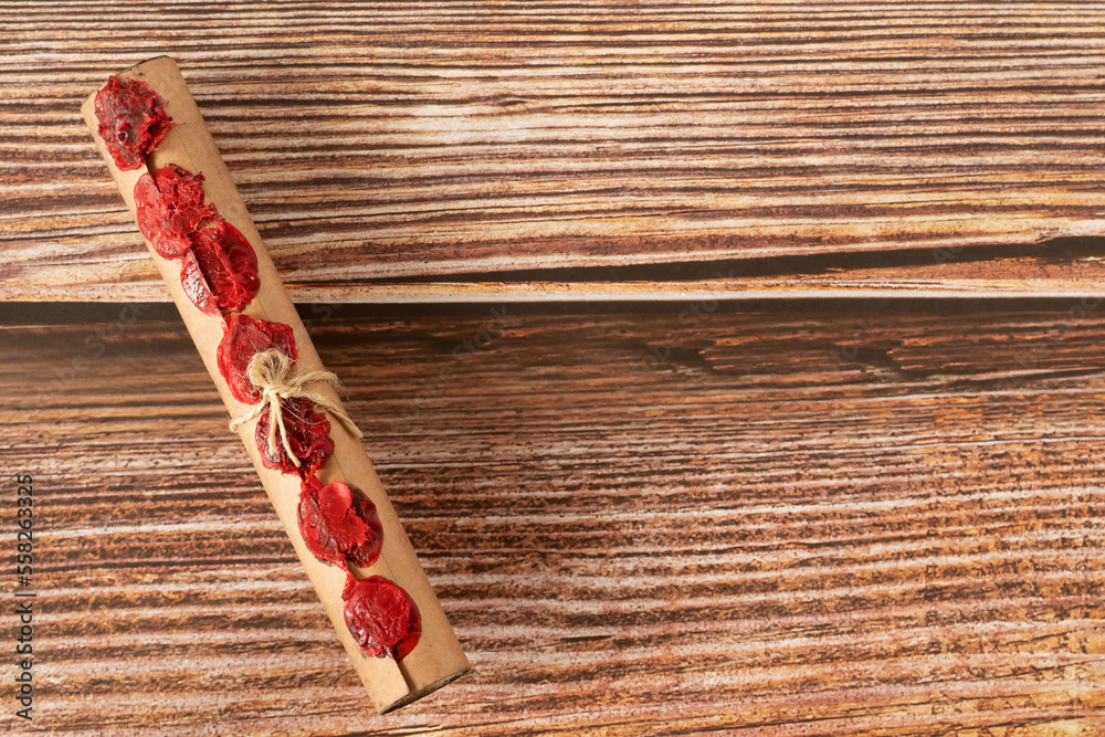 Old scroll with seven waxed seals on wooden background with copy space ...