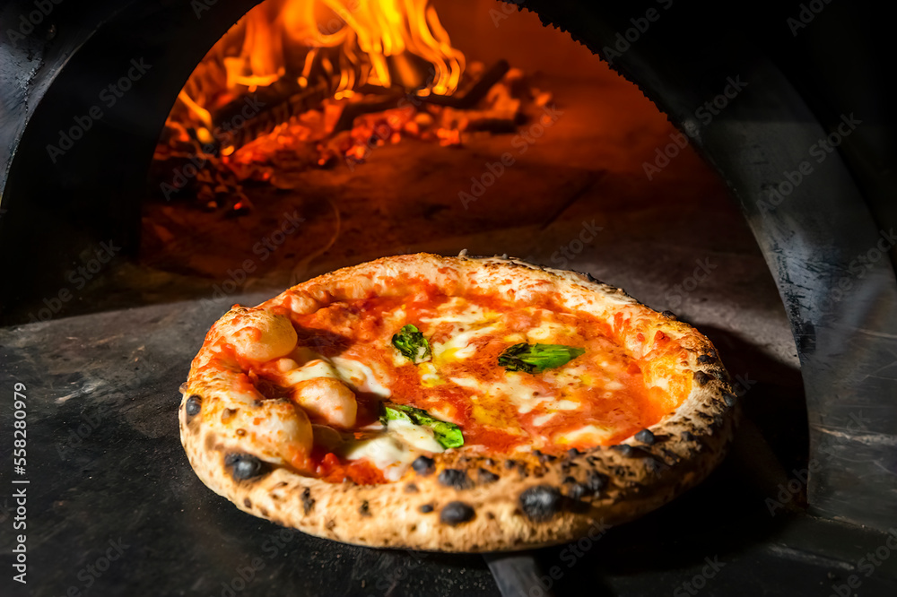 Foto de Pizza Margherita straight from a wood-fired oven. Close-up, baked in a wood-fired pizza ...