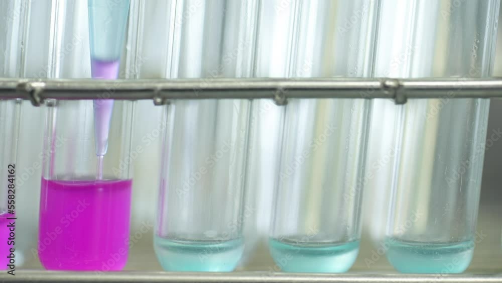 Microbiological Scientist inject liquid or dropping from pipette into ... Microbiological Scientist inject liquid or dropping from pipette into ...