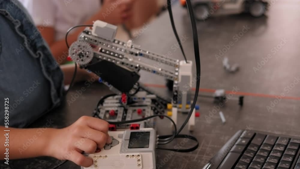 Close-up of a group of children playing with robots assembled from ...