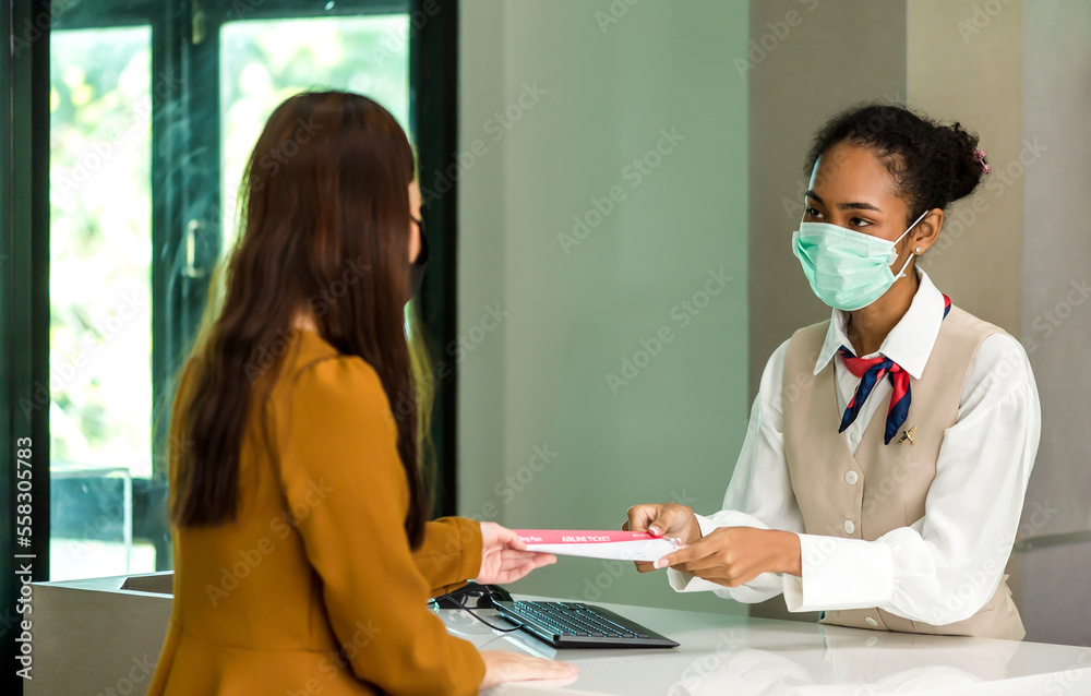Airline check in worker woman recieve ticket and boarding pass from ...