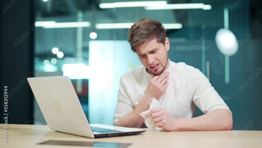 Sick IT programmer blowing running nose sneeze and cough while working ...