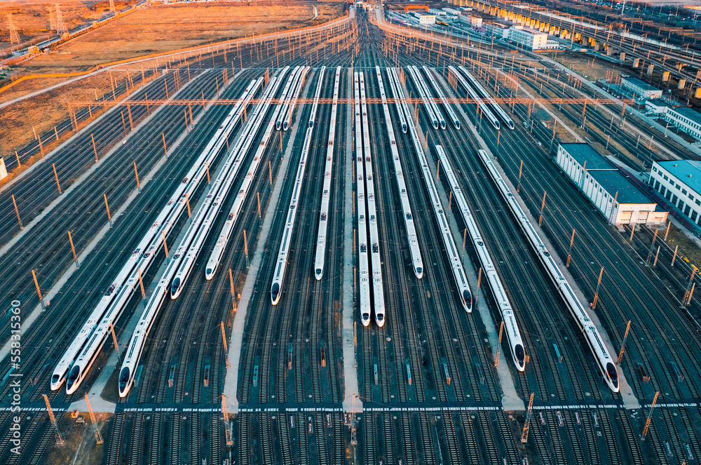 Aerial shots of multiple high-speed trains parked on railway tracks ...