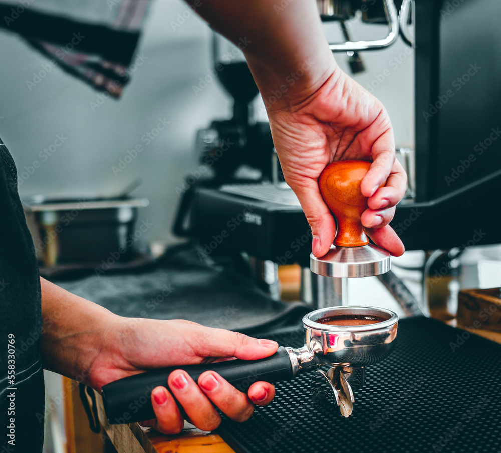 Close-up of hand Barista cafe making coffee with manual presses ground ...
