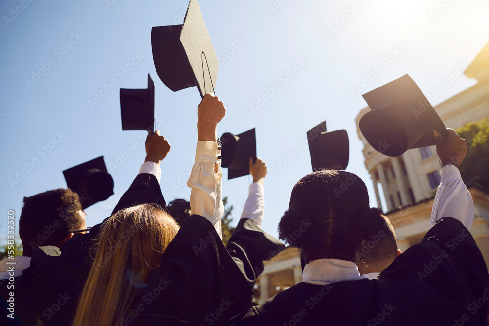 Students who finished studies raise hats high in air on graduation day ...