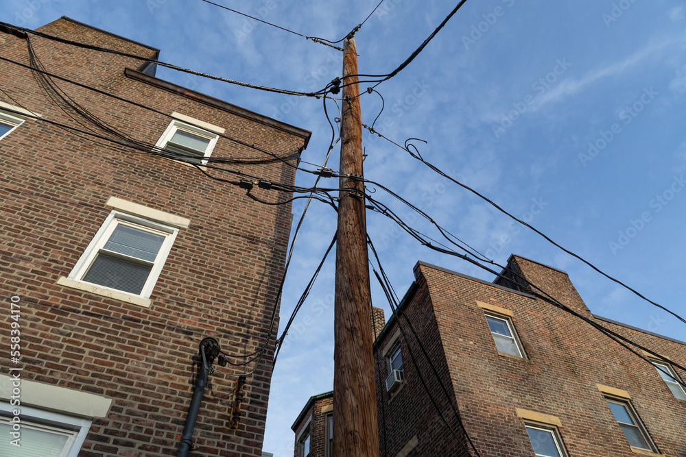 Upward view of the rear of two urban brick apartment buildings with a ...