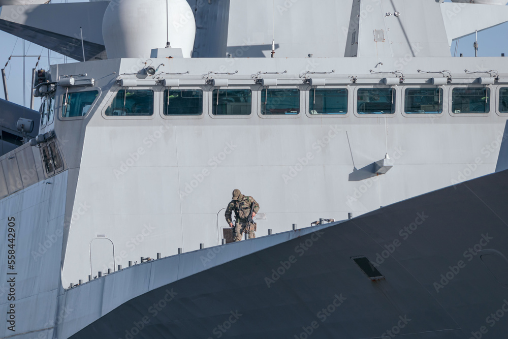 An armed soldier aboard an army warship. Security of army ships Stock ...