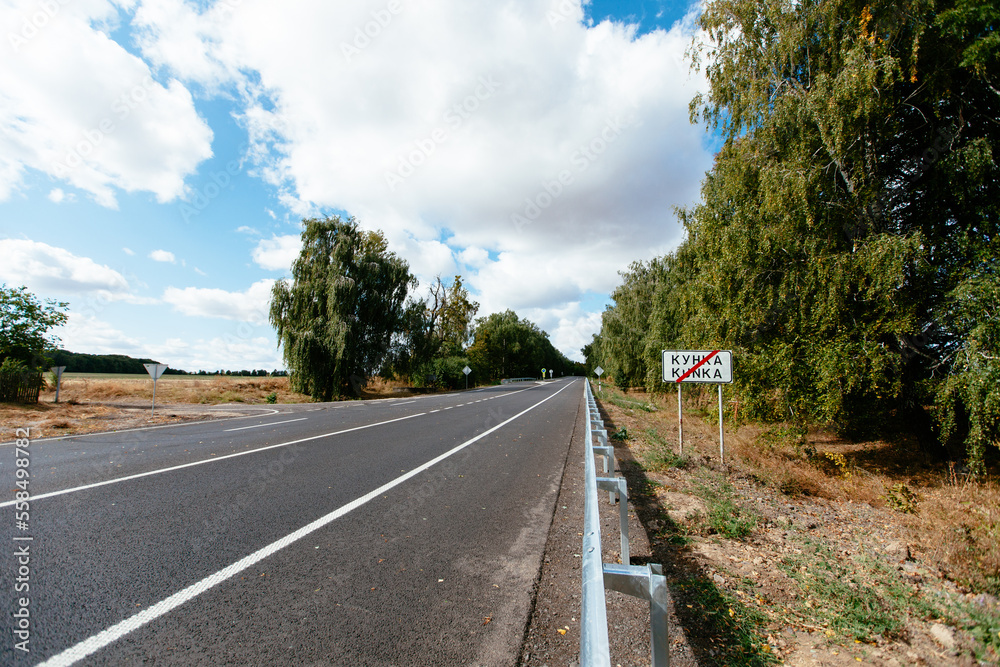 New asphalt road with markings and road signs in the sun's rays Stock ...