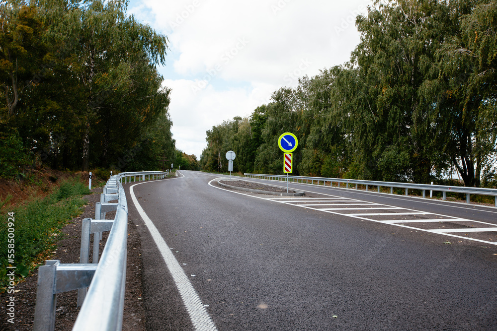 New asphalt road with markings and road signs in the sun's rays Stock ...