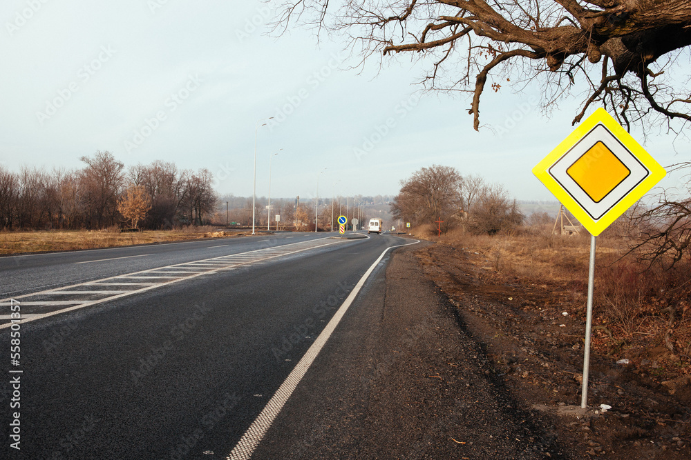 New asphalt road with markings and road signs in the sun's rays Stock ...