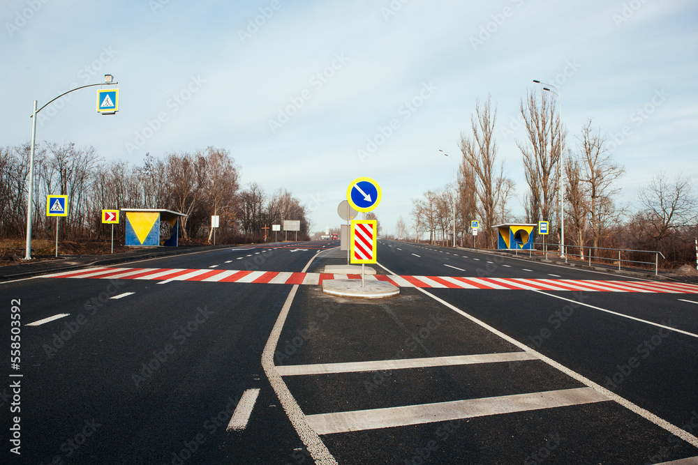 New asphalt road with markings and road signs in the sun's rays Stock ...