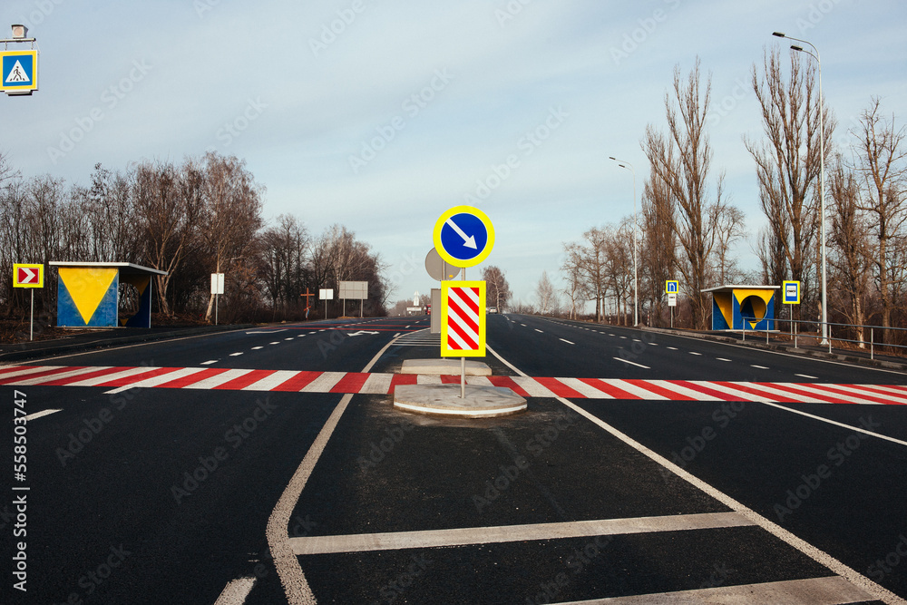 New asphalt road with markings and road signs in the sun's rays Stock ...
