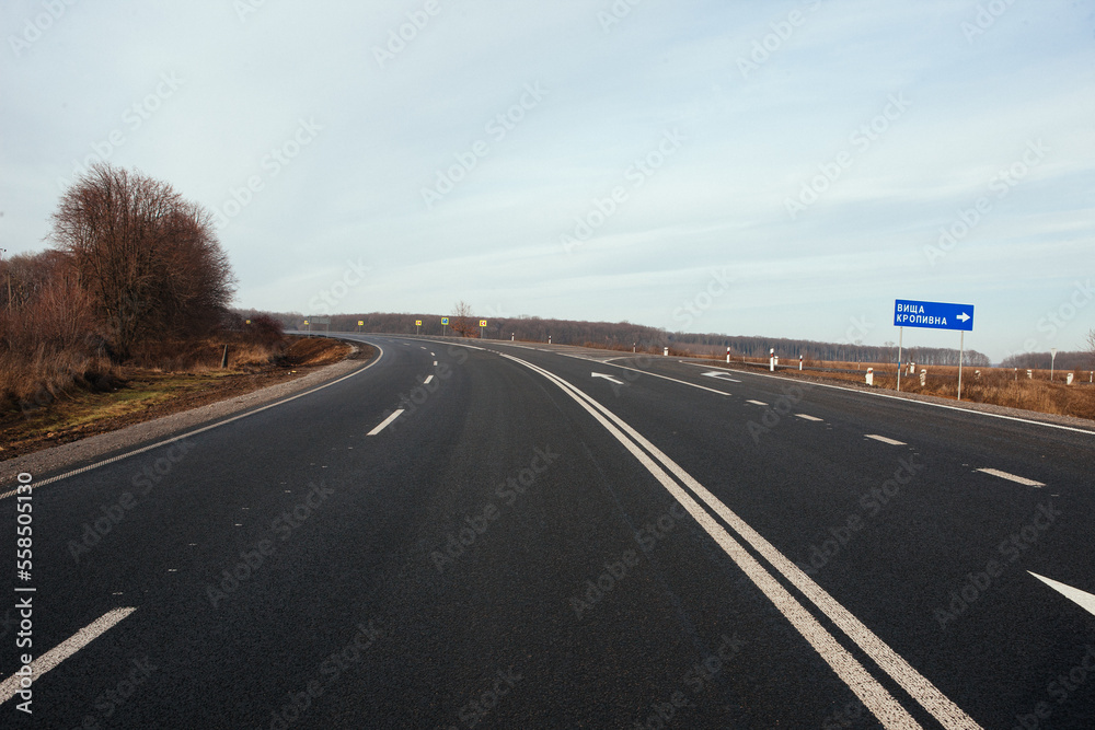 New asphalt road with markings and road signs in the sun's rays Stock ...