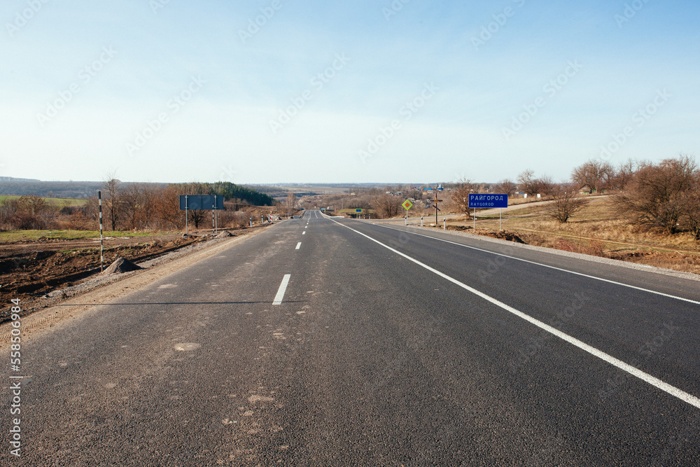 New asphalt road with markings and road signs in the sun's rays Stock ...