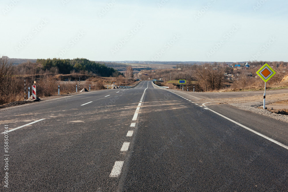 New asphalt road with markings and road signs in the sun's rays Stock ...