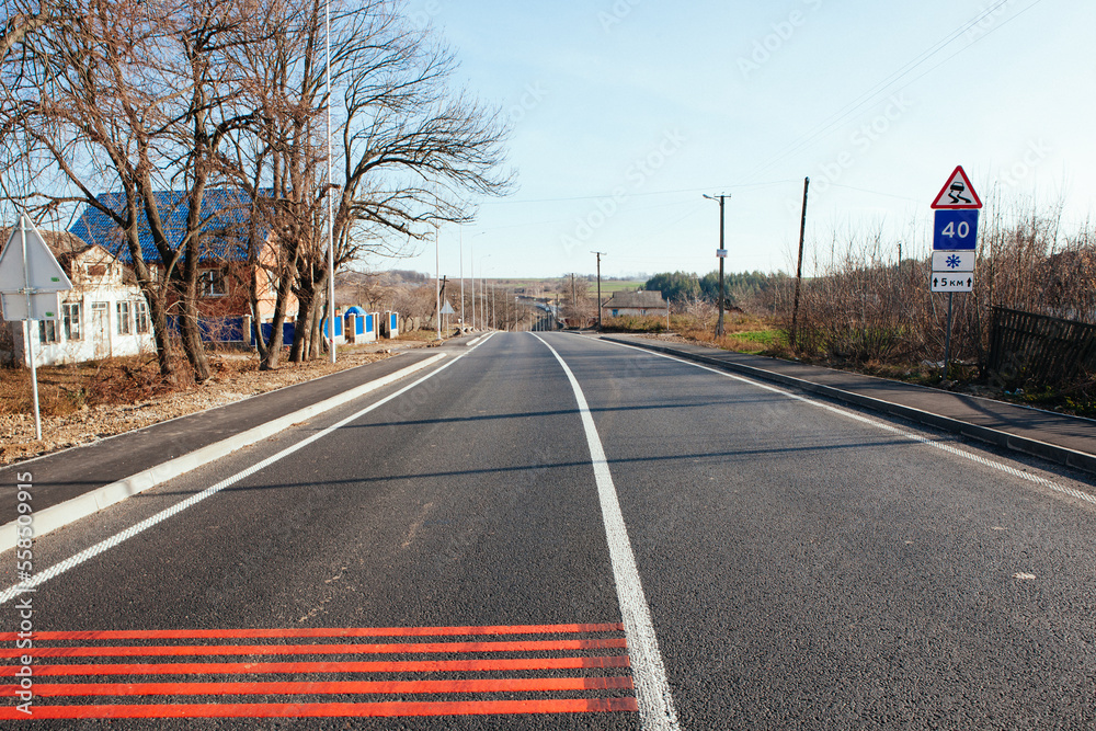 New asphalt road with markings and road signs in the sun's rays Stock ...