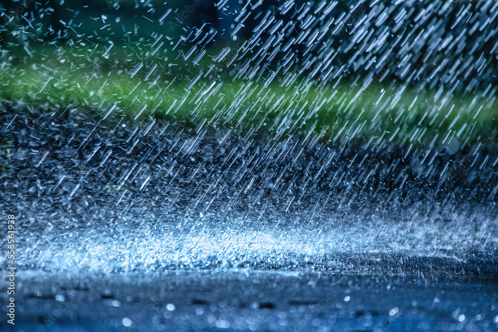 Raindrops fall on the asphalt. close up Deterioration of weather ...