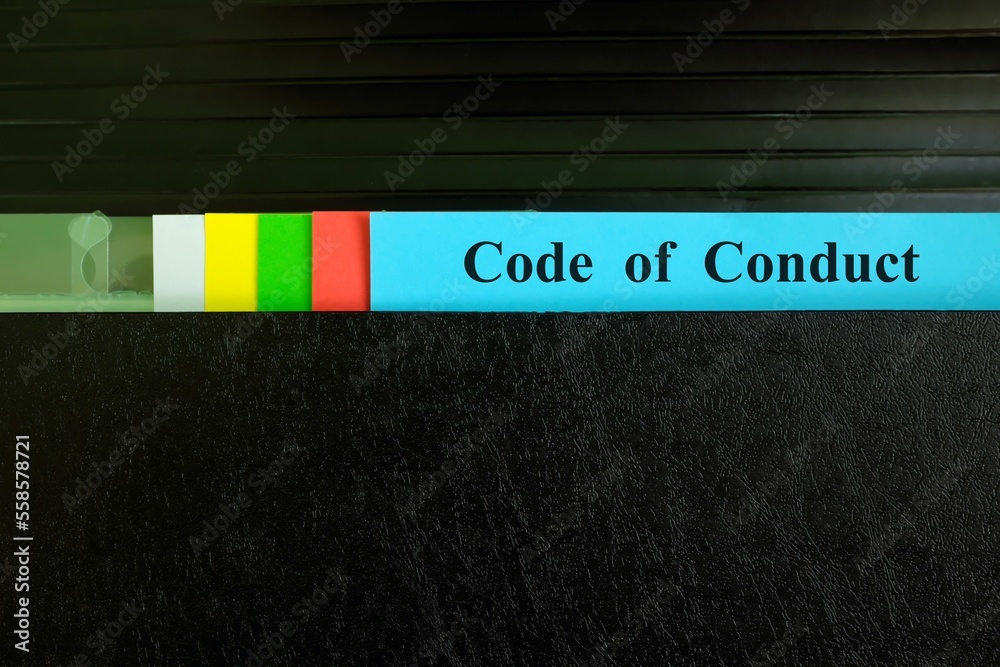 Code of conduct file record in black binder folder. Company code of ...