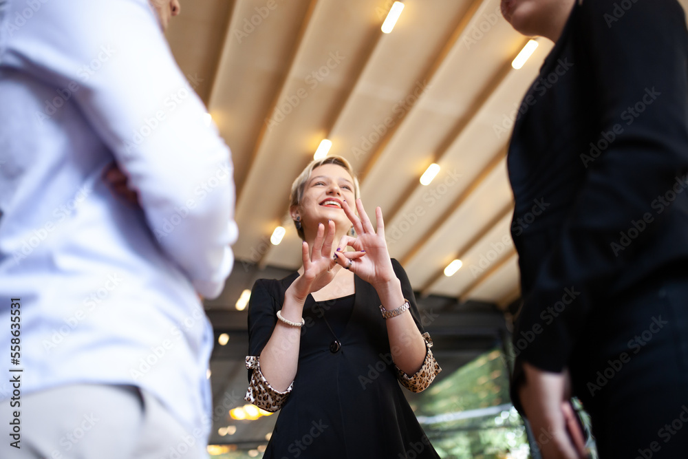 Three young business colleagues having fun conversation and making ...