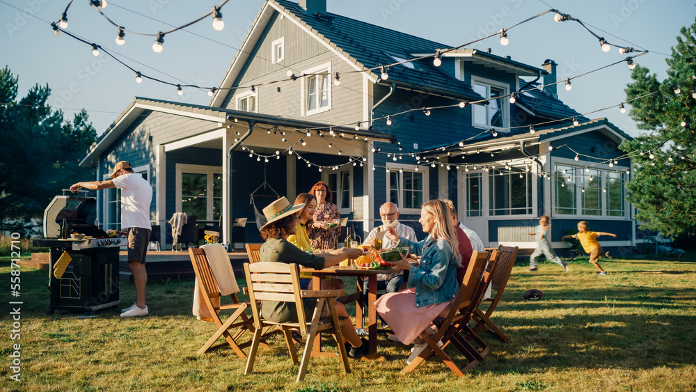 Parents, Children and Friends Gathered at a Barbecue Dinner Table ...