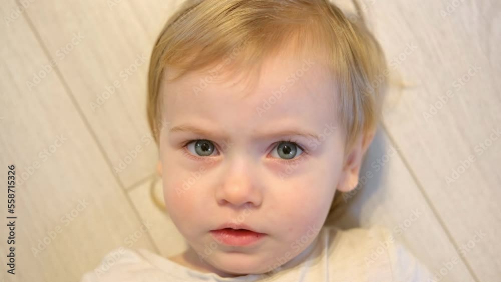 Little Girl looking intently to the Camera. Her gaze is curious, intent ...