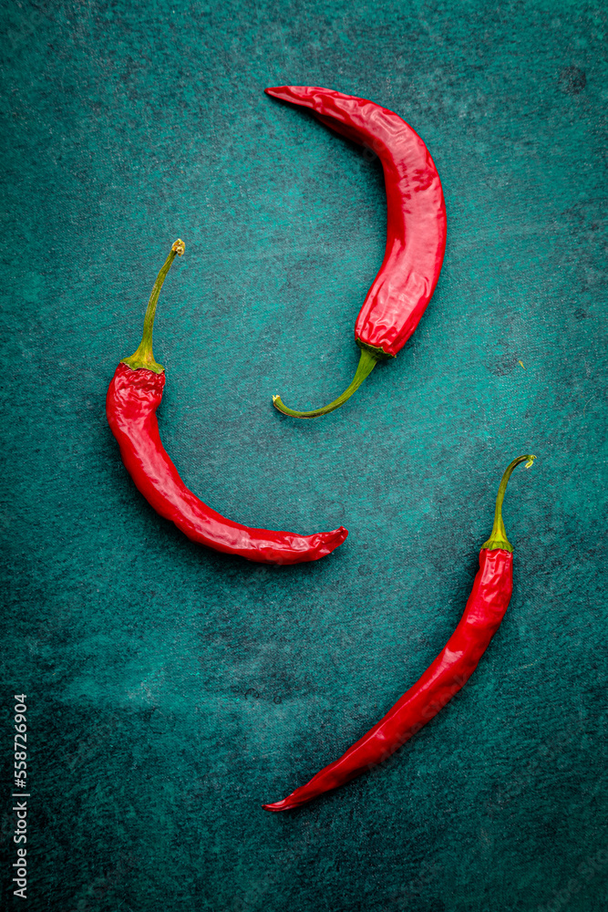 Chilli peppers over green background Stock Photo | Adobe Stock