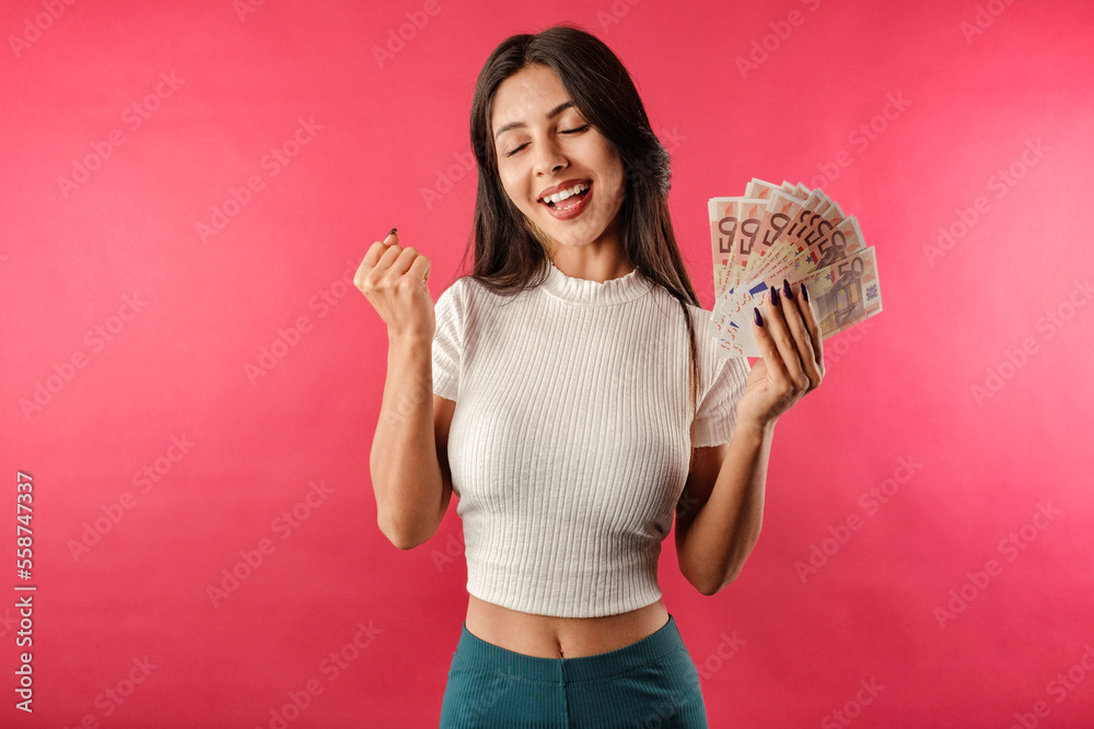 Happy young woman wearing white ribbed crop isolated over red ...