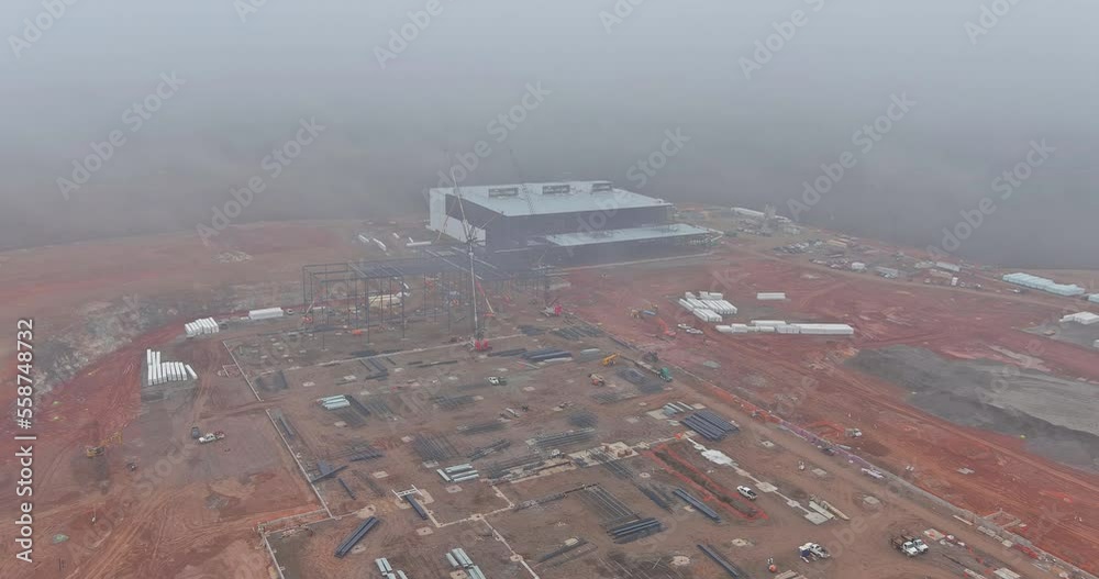 Construction site at dawn at times when heavy fog use tower cranes work ...
