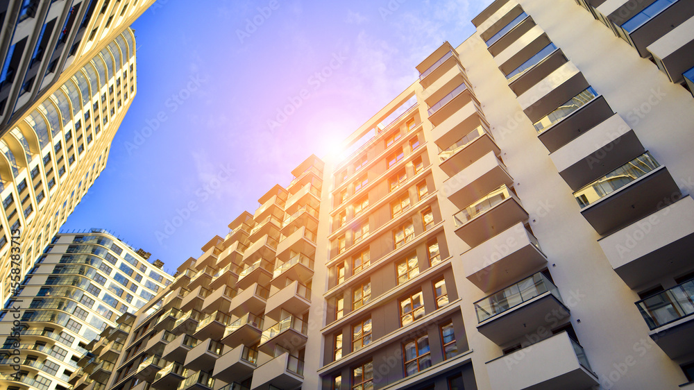 The narrow passage between modern residential buildings. Walls of high ...
