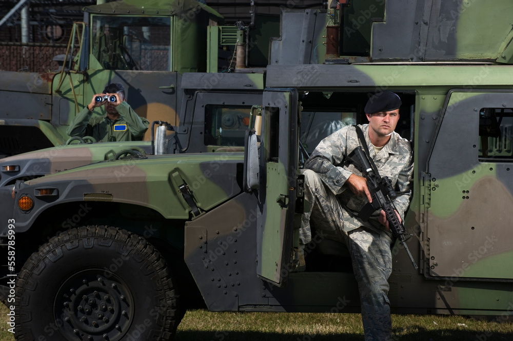 Military police officers secure tactical vehicles on base. Stock Photo ...