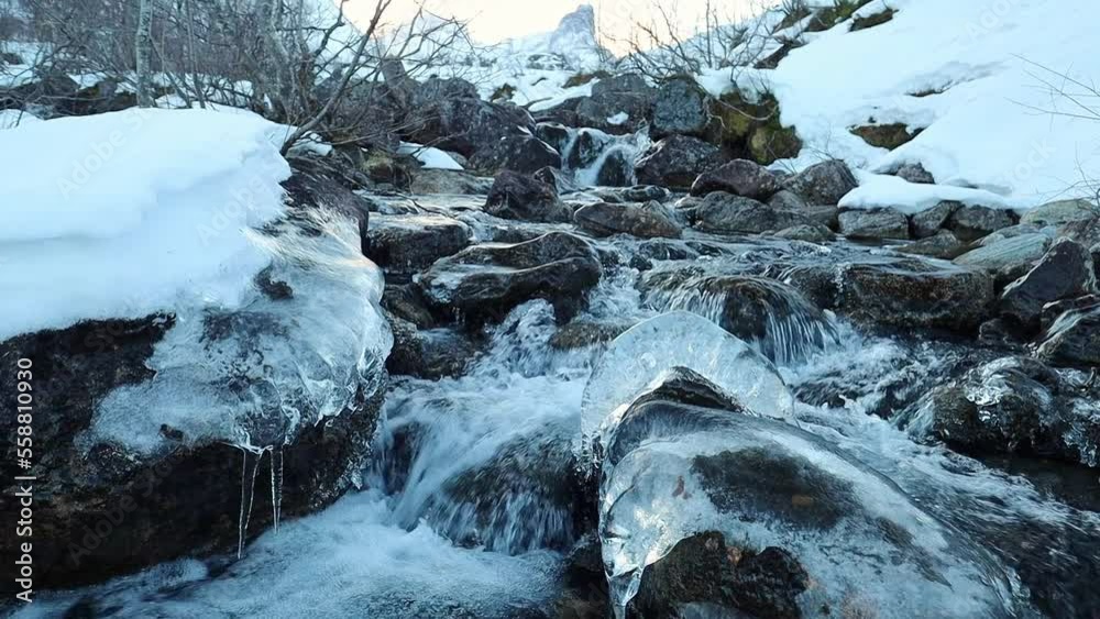 Freezing mountain stream in the valley Venjesdalen in Norway. Cold and ...