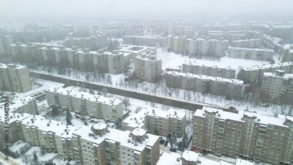 Aerial view of apartments houses in winter, snowy environment, flying ...