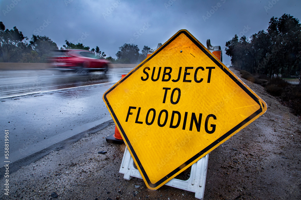 Road Sign stating Subject to Flooding with rainy highway in the ...