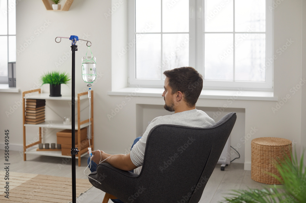 Rare view of male patient receiving intravenous treatment. Young man ...