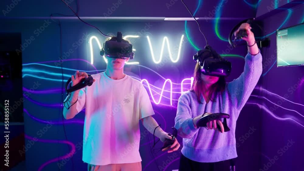 Cyber gamer in VR glasses plays virtual reality game in neon futuristic ...