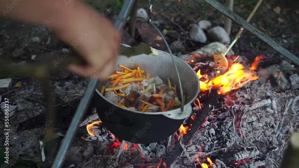 Cooking over a campfire. Cooking at the campsite . The concept of ...