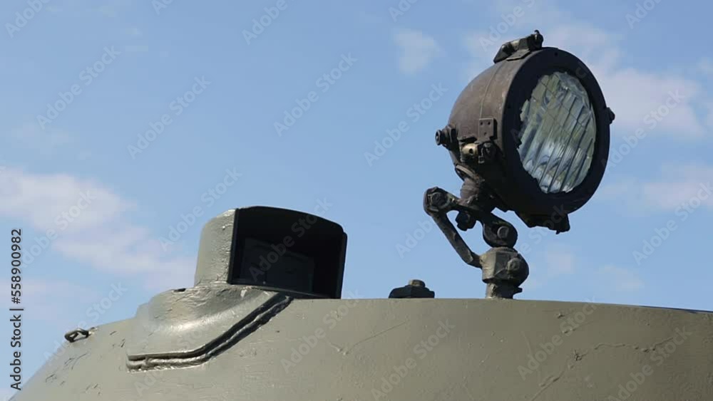 Front headlight of a Soviet battle tank. Very bright searchlight on the ...