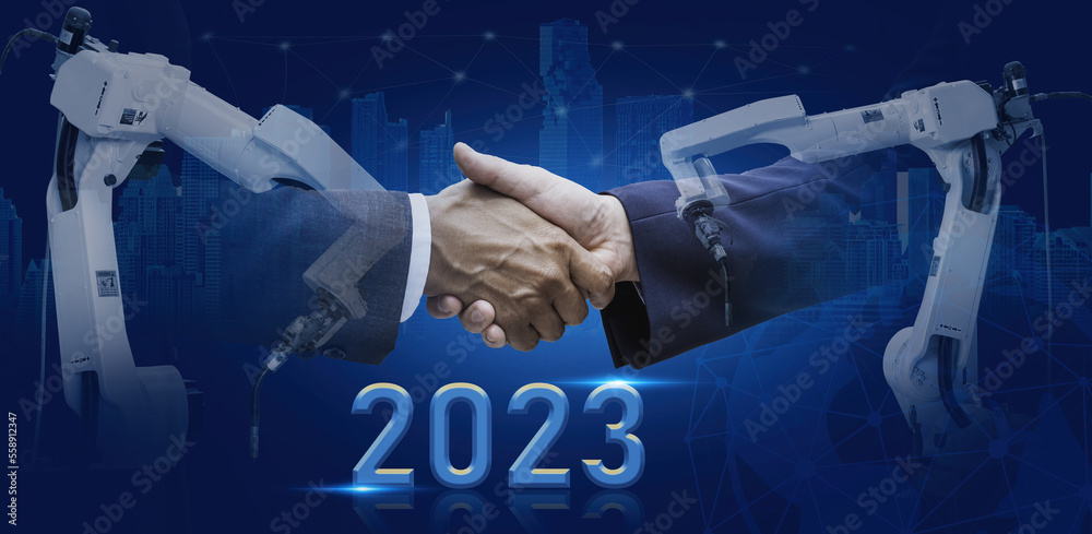 Robot hand with businessman handshake on year 2023 showing intelligence ...