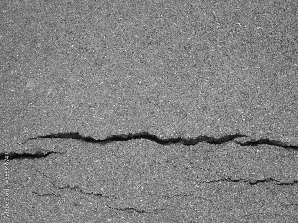 Earthquake disaster background. Cracks of road surface. Broken tarmac ...