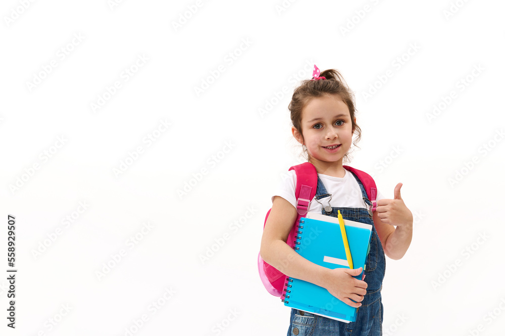 Lovely cheerful little child girl, primary school student with pink ...