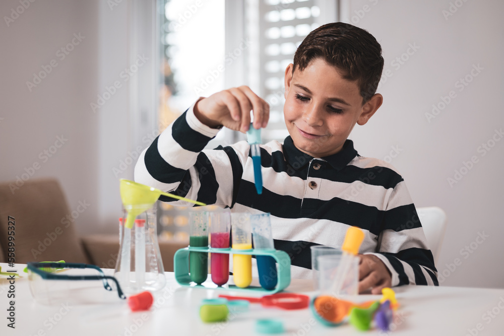 Boy having fun with chemistry lab in his living room. Science ...